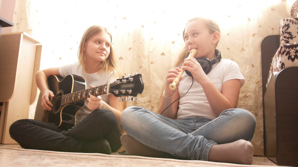 videoblocks-two-teenagers-sisters-playing-musical-instruments-at-home ...